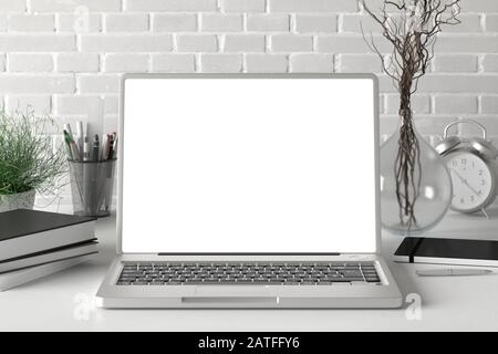 Business laptop with white brick wall Stock Photo - Alamy