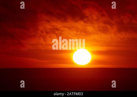 Large Sun Setting over the Pacific Ocean Stock Photo - Alamy