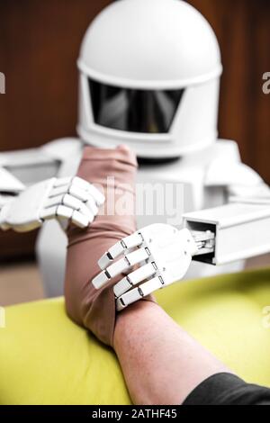 assistance medicine service robot is putting a bandage on a arm of an ...