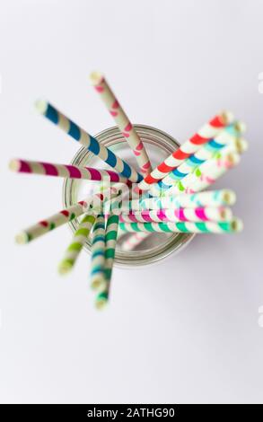 Retro style stripped paper straws on black background Stock Photo - Alamy