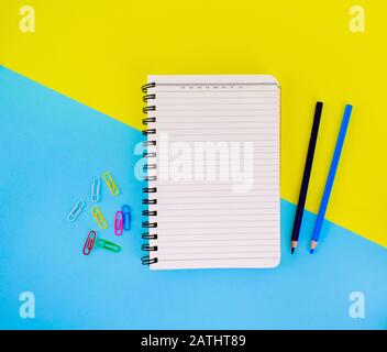 Blue paper clips on color background Stock Photo - Alamy