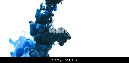 Mix of black and classic blue ink in water isolated on white background ...