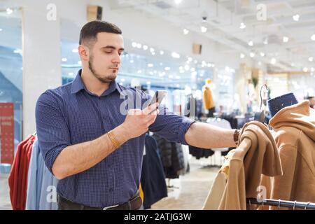 Guy buyer scans qr code on liquid detergent while shopping Stock Photo ...