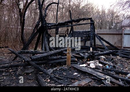 Burnt wooden house, black charred skeleton of a country house. Charred ...