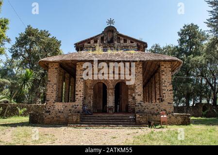 Debre Berhan Selassie historic church side passage with priest in ...