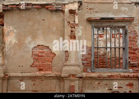 rendered concrete wall with exposed red brick and wooden jail cell like ...