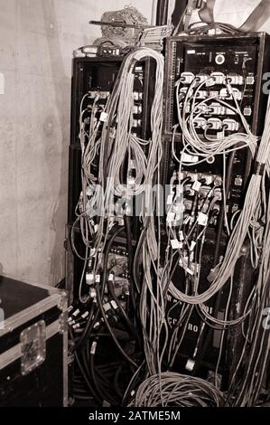 A mess of tangled black cords and cables Stock Photo - Alamy