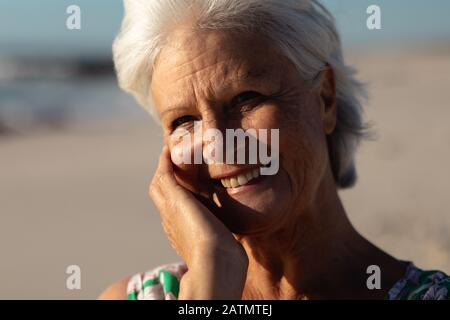 Old woman smiling at the beach Stock Photo - Alamy