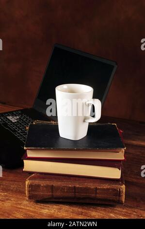 Home office workplace with stack of old books and headphones. With copy ...