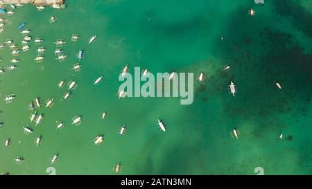 Aerial view of traditional Filipino Banca outrigger canoes lying in the ...