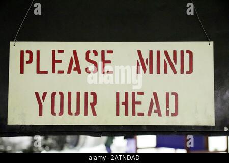 Please mind your head warning sign Stock Photo - Alamy