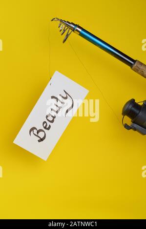 fishing line with piece of paper hanging of as symbol for temptation in ...