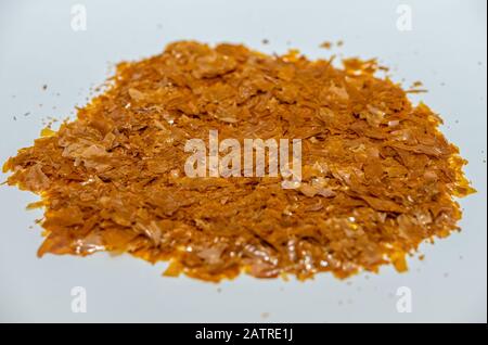 Natural shellac in flakes, which is used as food glaze and wood finish ...