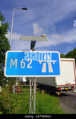 traffic passing m62 motorway sign to leeds and manchester at normanton ...
