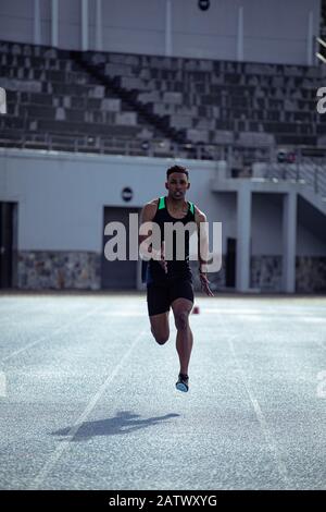 Athlete running in a stadium Stock Photo - Alamy