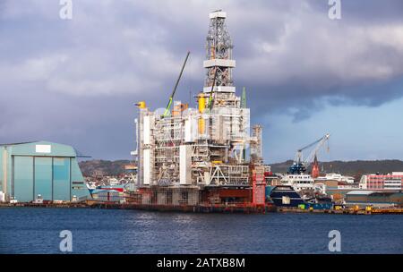 Offshore drilling rig under construction in a fiord in Norway. Oil ...