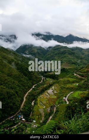 View of a valley in Banaue in the Philippines where a river is ...
