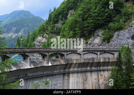 The ancient concrete dam forms the artificial basin of Lake Sauris ...