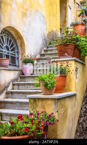A beautiful view of a narrow staircase in the middle of walls Stock ...