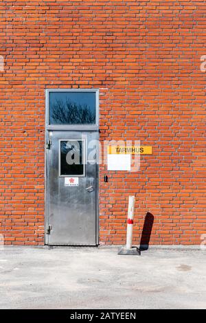 Danish Crown Slaughterhouse, "Tarmhus", sign by door in red brick wall ...