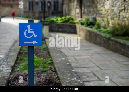 Disabled sign pointing to a wheelchair path Stock Photo - Alamy