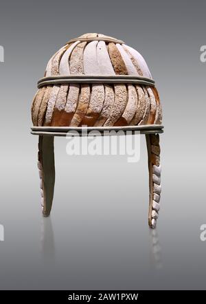 Boar's tusk helmet with cheek guards and double bone hook on top. Tomb ...