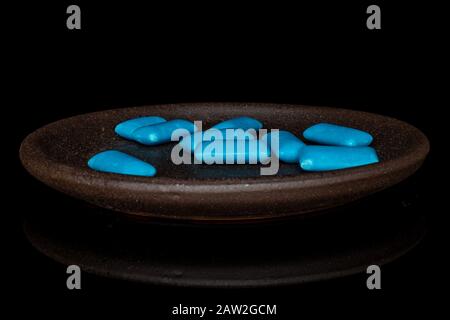 Group of nine whole blue chewing gum one bolus in focus isolated on ...