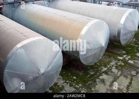 Large fuel tanks. Tanks and ladders of the tank farm. The gloomy ...