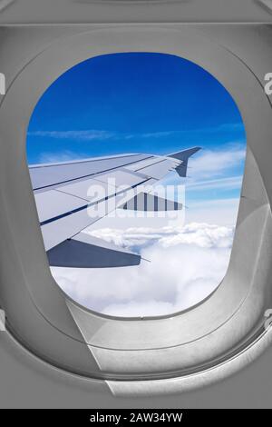 A closeup view of an airplane wing over the fluffy clouds Stock Photo ...