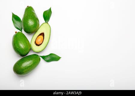 Summer food pattern. Avocado halves on blue background. Top view. Flat ...