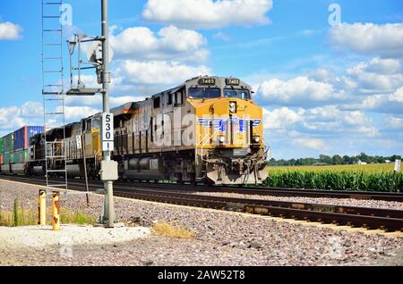 A Union Pacific intermodal freight train rolls across a snowy winter landscape in Northern ...