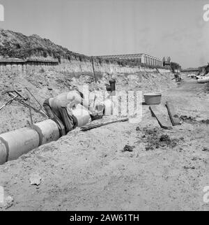 Construction worker of laying drainage pipe for rainwater in during ...