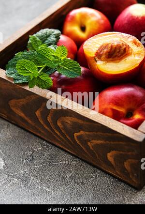 Box with fresh nectarines on a stone background Stock Photo - Alamy