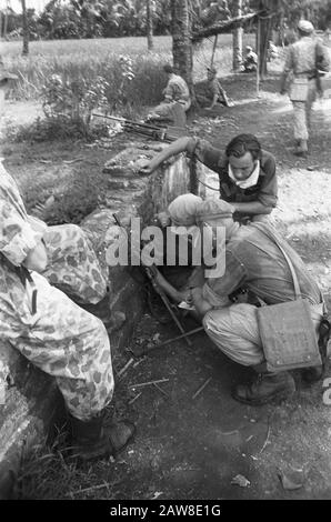 Operation near Keboemen, Tjilatjap Patrol. Three soldiers moving ...