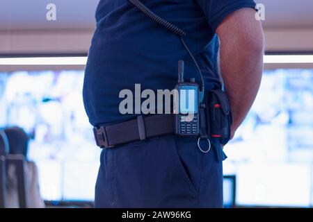 Male security guard using radio transmitter in surveillance room Stock ...