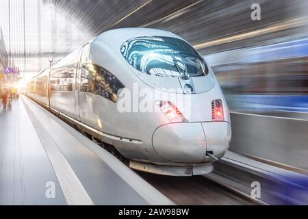 super streamlined train with motion blur moves from city Stock Photo ...