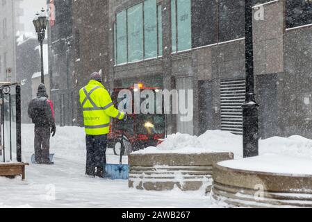 Man Removing snow with a shovel during snowfall Stock Photo - Alamy