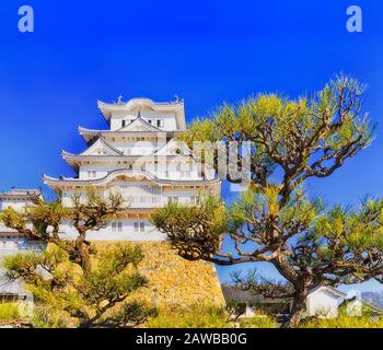 The famous heritage, Osaka castle under bright blue dramatic cloudy sky ...