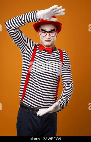 Funny mime artist with blank sign on white background Stock Photo - Alamy