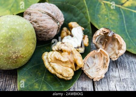 green walnut kernels leaves wooden table oil nuts unripe husks healthy ...