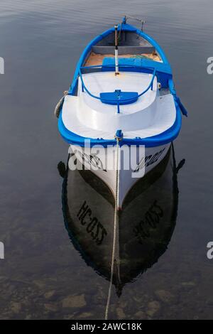 A fishing boat in sea on a hot cloudless day Stock Photo - Alamy