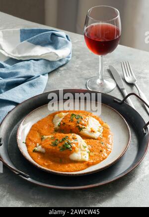 Spanish style salted cod cooked with vegetables peppers, tomatoes, and ...