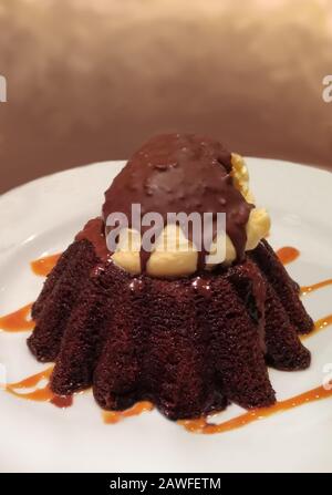A vertical shot of a caramel hot chocolate on the white background ...