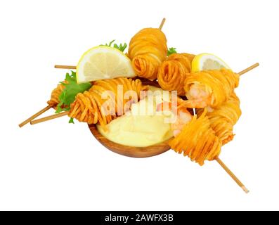 Potato string spiral wrapped king prawns on wooden skewers with a small ...