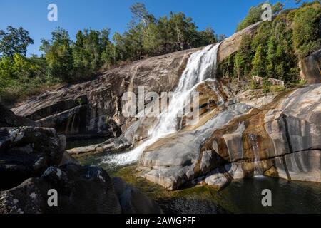 Murray Falls spilling over pink granite rock shelf. Girramay National ...