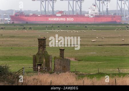 Cliffe Marshes in kent UK. A ship in background sailing up the River ...