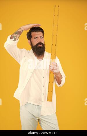 One meter. Man bearded hipster holding ruler. Measure length. Size tall ...