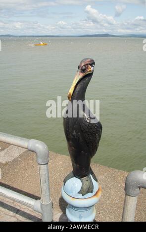 A metal Cormorant sculpture on the promenade at Morecambe in Lancashire ...
