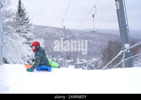 A boy on bob sleight in snow Stock Photo - Alamy