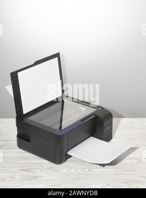 Laser home printer on table against white backgorund Stock Photo - Alamy